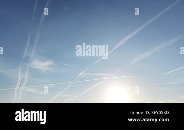 Jet trail patterns stretching through calm morning sky Stock Video ...