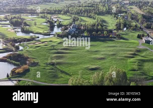 Golf course landscape with lakes and dense forest background Stock ...
