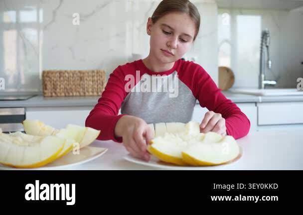 Teen Girl Eating Melon Sitting At The Kitchen Table Stock Video Footage ...