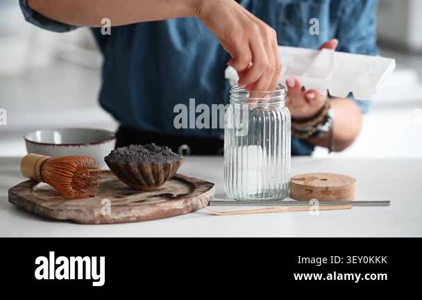 Woman Adds Ice To Make A Blue Iced Matcha Latte Stock Video Footage - Alamy