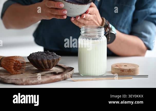 Woman Pouring Blue Matcha Tea Into A Jar With Ice And Milk, Close-Up ...