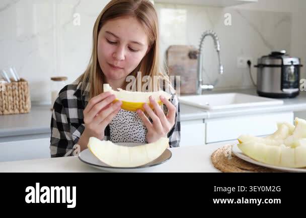 Teen Girl Eating Melon Sitting At The Kitchen Table Stock Video Footage ...