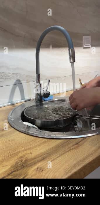 Woman hands wash dishes, housewife does household chores and cleaning ...