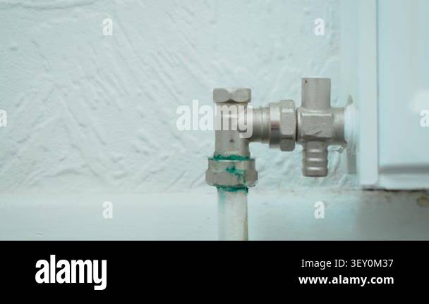 Heating radiator connection with corrosion buildup around metal valve ...