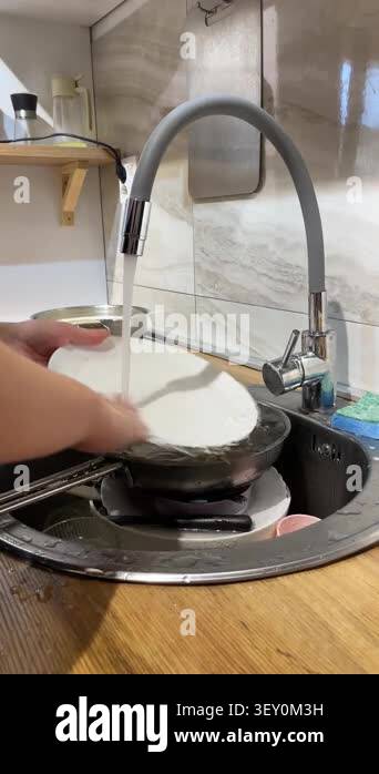Woman hands wash dishes, housewife does household chores and cleaning ...