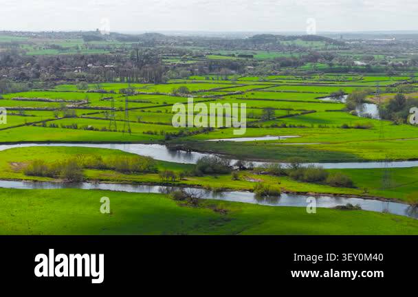 Detailed countryside scene with multiple river curves small ponds ...