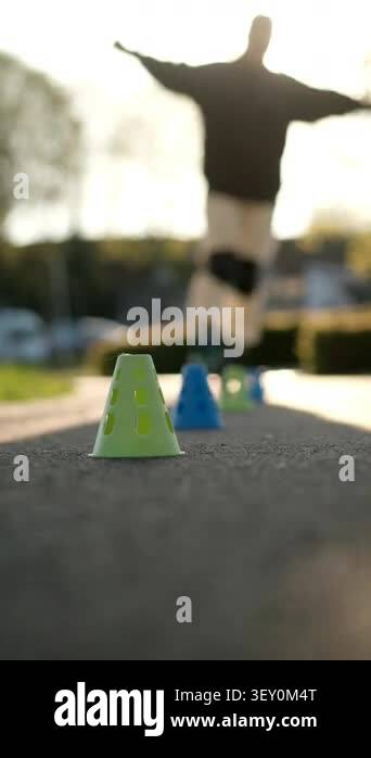 Girl on roller skates practices agility. She balances past blue and ...