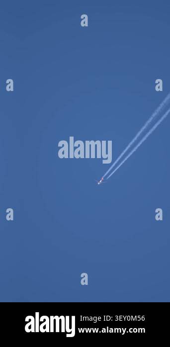 Airliner moving across sky with fading contrail stream behind, long ...