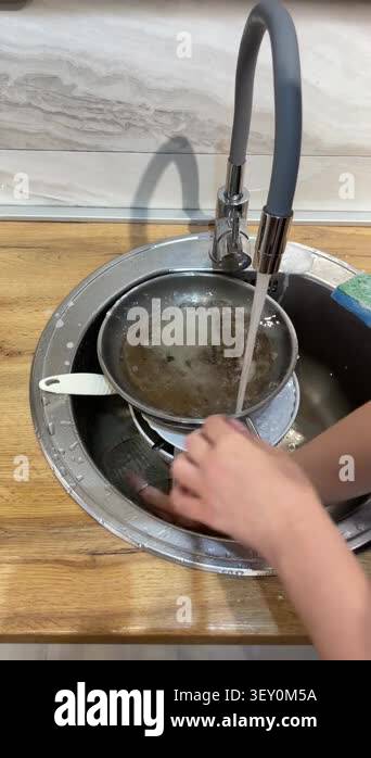 Woman hands wash dishes, housewife does household chores and cleaning ...
