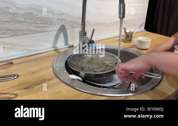 Woman hands wash dishes, housewife does household chores and cleaning ...