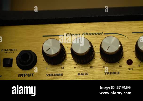 Guitar amplifier control panel with volume, bass, and treble knobs ...