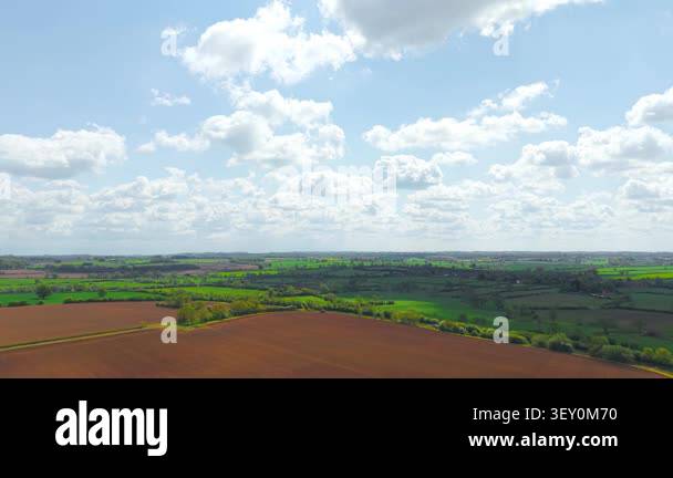 Wide rural horizon with cultivated fields beneath dramatic spring ...