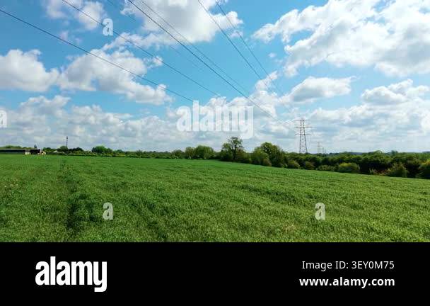 Wide agricultural landscape with wheat field under dramatic cloudscape ...
