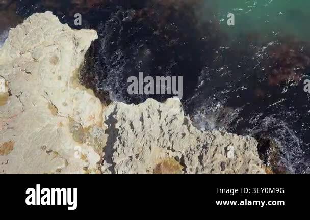 Aerial top view of turquoise sea wAn aerial top-down shot of vibrant ...