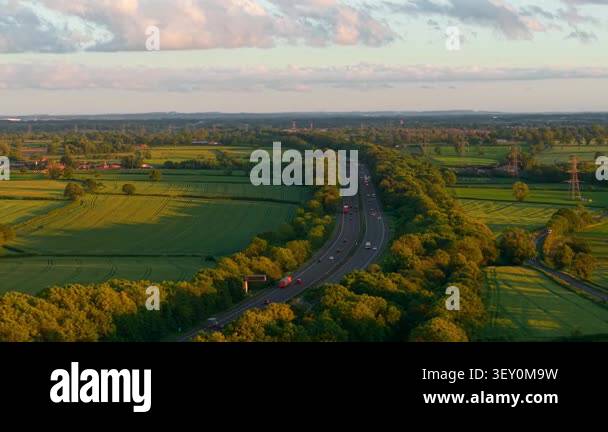 Motorway traffic freight transport across rural landscape. Aerial drone ...