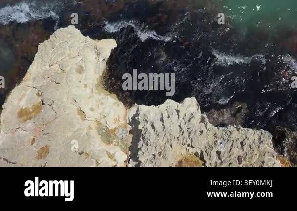 Aerial top view of turquoise sea wAn aerial top-down shot of vibrant ...