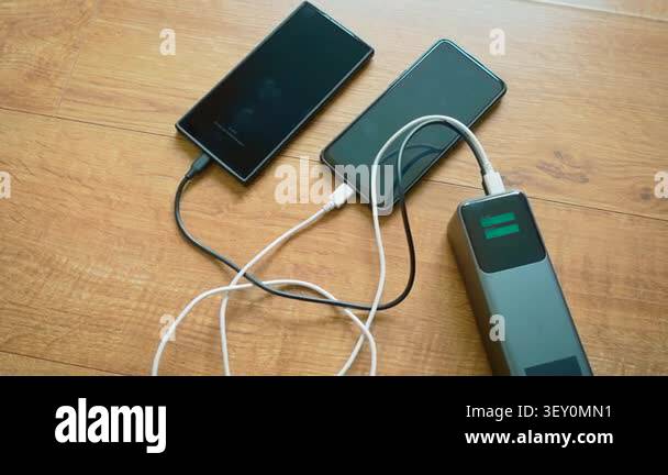 Dual smartphone charging from power bank using connected cables ...