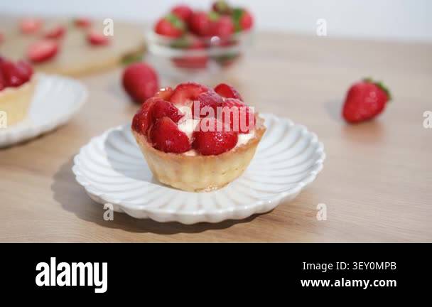 Strawberry tart on a white plate with blurred background Stock Video ...