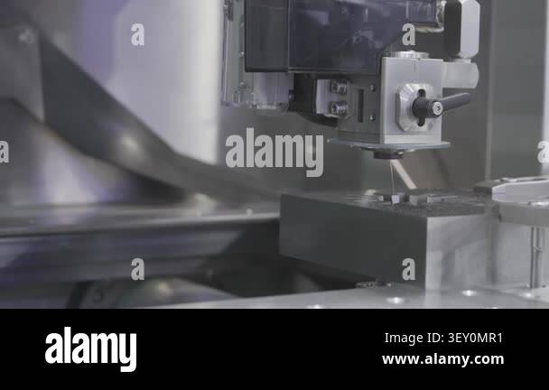 EDM Wire cutting machine working, Closeup Wire Electrical Discharge ...