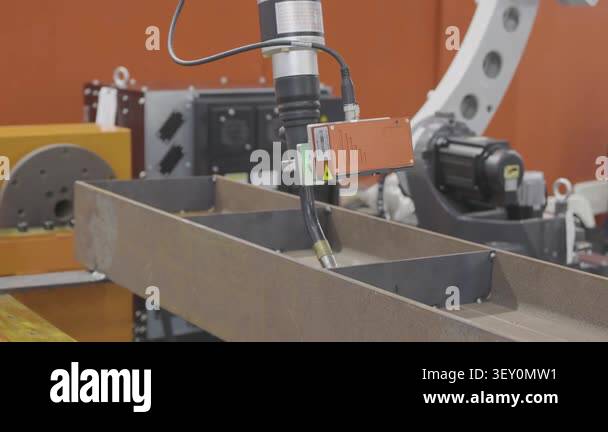 Robotic laser welding arm in automated manufacturing production line ...