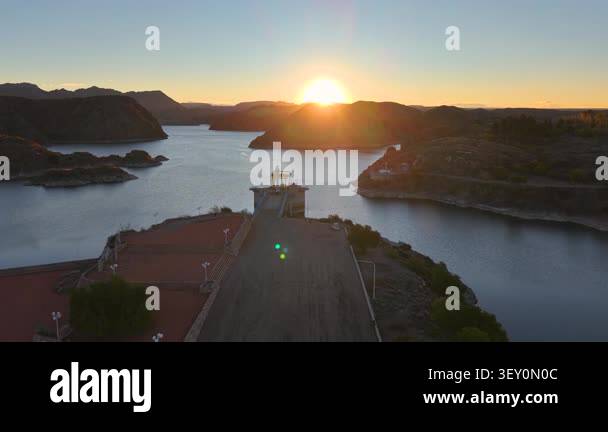Aerial view of Los Reyunos dam and hydroelectric power plant at sunset ...