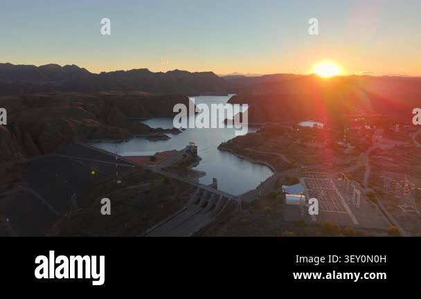 Aerial view of Los Reyunos dam and hydroelectric power plant at sunset ...