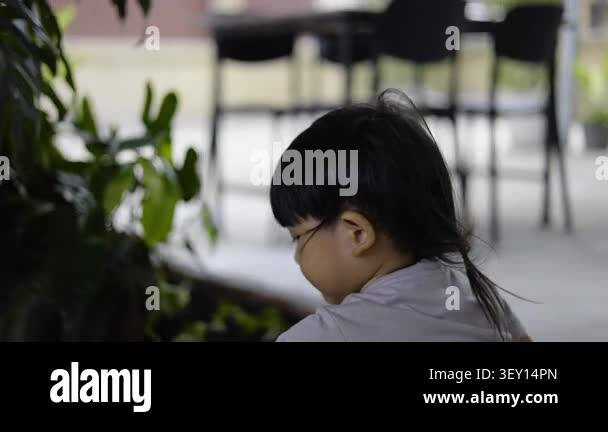 young asian boy is playing with a toy in the garden Stock Video Footage ...