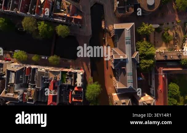 Tilted drone shot over an Amsterdam street reveals an orange aerial ...