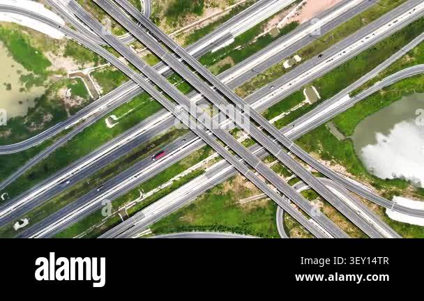Aerial footage of a modern highway interchange stretching through a ...