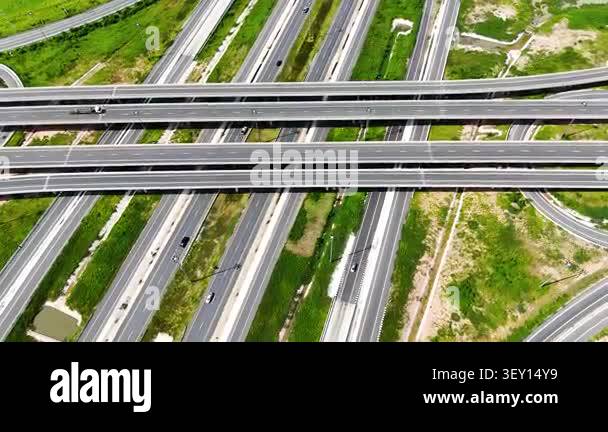 Aerial footage of a modern highway interchange stretching through a ...