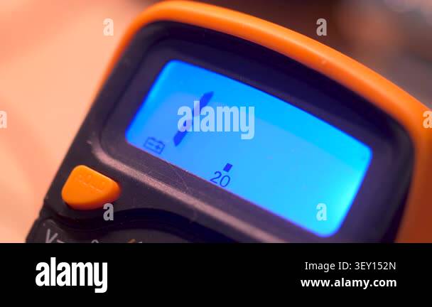 Close-up of a digital multimeter measuring an electronic component ...