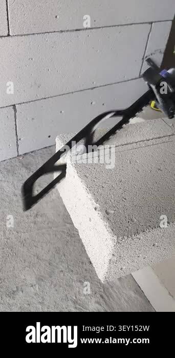 Slow motion close-up of an electric reciprocating saw cutting an ...