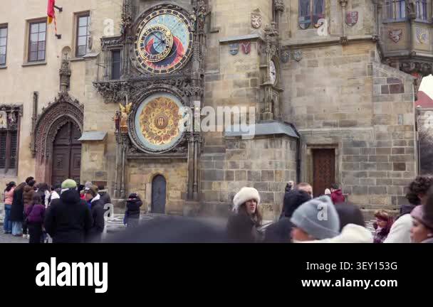 Tourists gather in front of a medieval astronomical clock on a Gothic ...