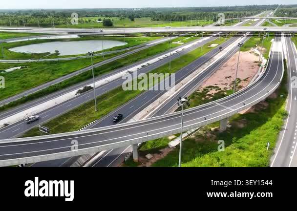 Aerial footage of a modern highway interchange stretching through a ...
