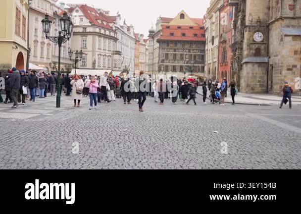 A crowd gathers near the Astronomical Clock and historic buildings in ...