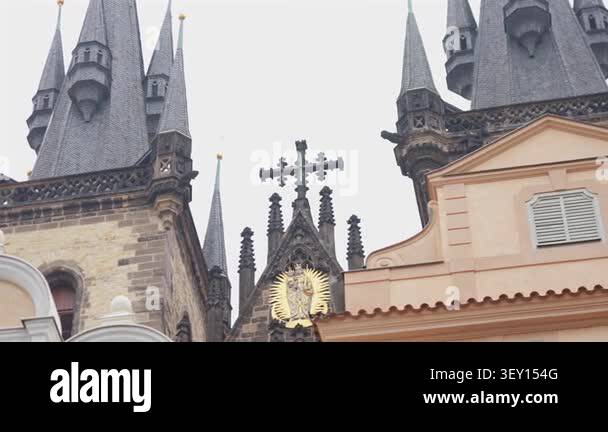 Gothic church spires and a golden religious statue rise above historic ...