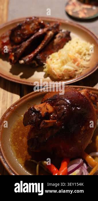 Roasted Czech pork knuckle with pickled vegetables and baked potato ...
