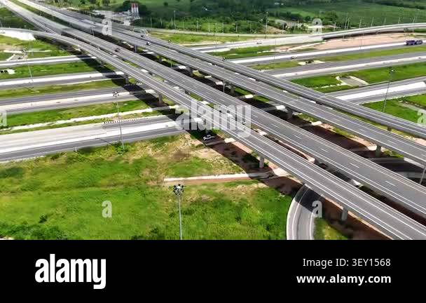 Aerial footage of a modern highway interchange stretching through a ...