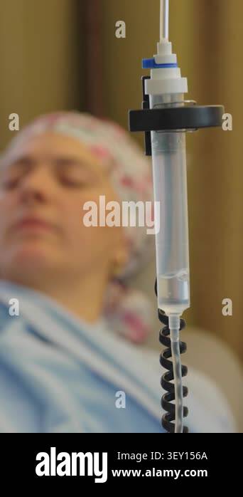 Close view of chemotherapy drip chamber capturing individual medication ...