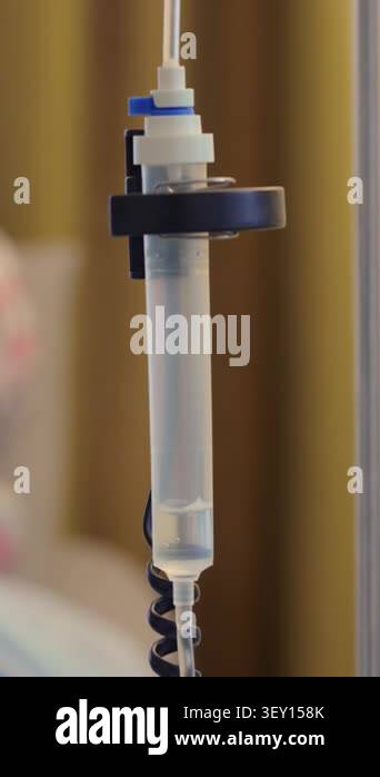 Close view of IV infusion equipment showing fluid chamber and delivery ...