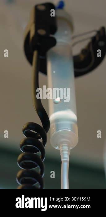 Close perspective of IV infusion equipment showing fluid chamber and ...