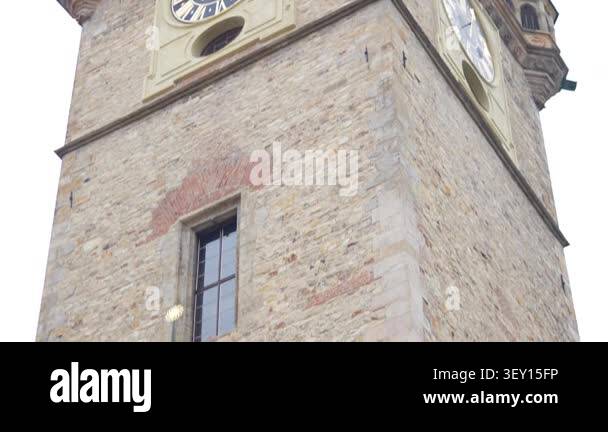 Close up tilt view of a medieval stone tower with an astronomical clock ...