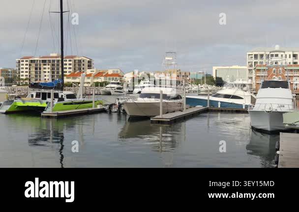 Yachts and catamaran moored at marina floating docks Stock Video ...