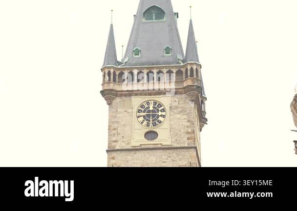 A historic clock tower rises above Old Town rooftops and Gothic stone ...