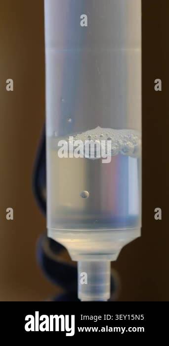Detailed close up of infusion equipment capturing a single drop moving ...