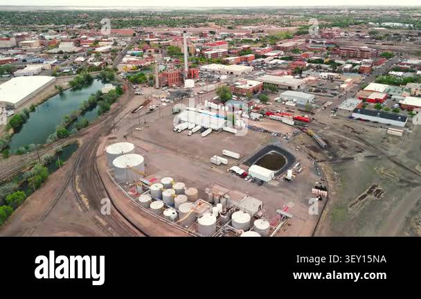 Drone orbiting Pueblo Colorado industrial riverfront area with large ...