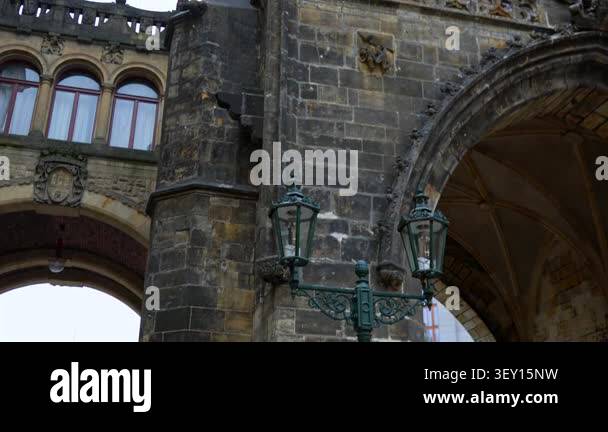 A Gothic tower facade shows intricate stone carvings and statues while ...