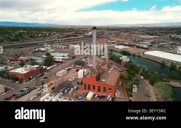 Drone orbits above Pueblo Colorado riverfront industrial district with ...