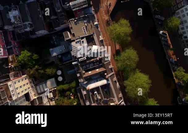 Drone looks down at a modern city building rooftop fitted with solar ...