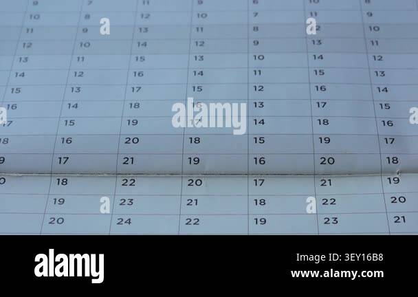 Close up and panning view of yearly calendar, showing dates, numbers ...
